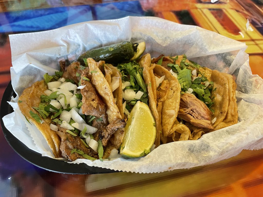 Three hearty tacos! El Mariachi seems to grill the corn tortillas in ...